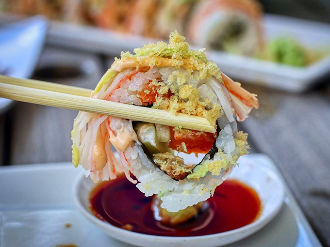 Vibrant orange tobiko pops against creamy avocado slices, creating a roll that's as visually striking as it is deliciously complex.