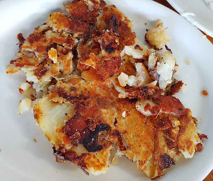 Hash browns achieving their highest calling: golden, crispy, and seasoned well enough to make potatoes proud of their life choices.