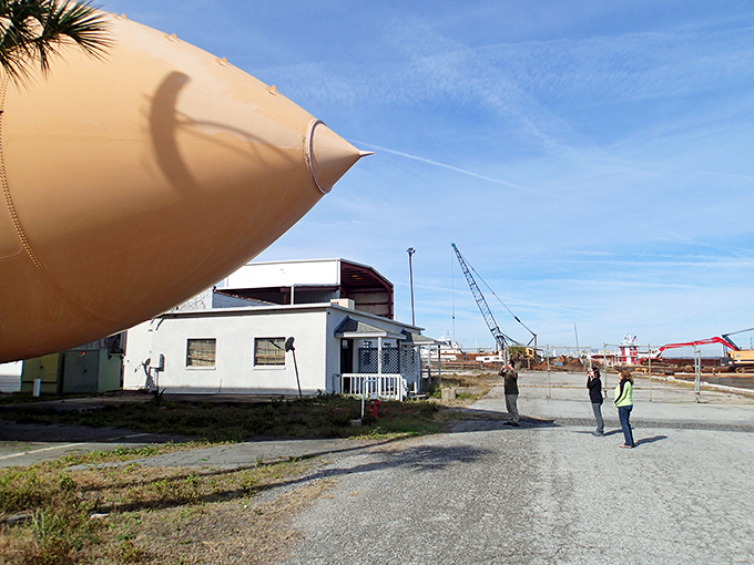The tank's massive scale turns visitors into ant-sized spectators. Standing beneath it feels like being in a sci-fi movie where everyday humans discover alien technology.