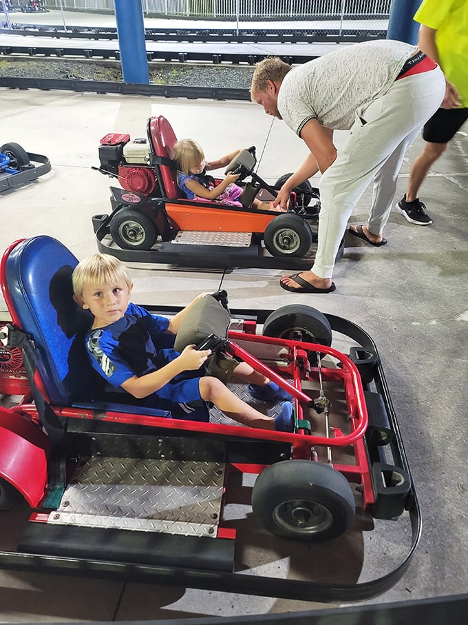 Young racers grip their go-kart steering wheels with Formula One intensity, the thrill of competition lighting up their faces.