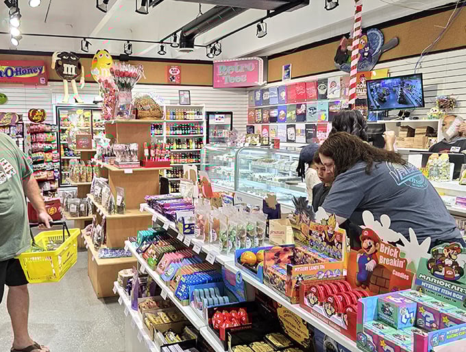 M&M characters stand guard over a rainbow of bottled sodas &ndash; the unofficial mascots of this sugar sanctuary.
