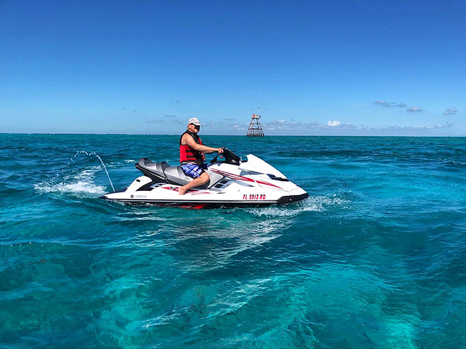 Nothing says "I'm living my best life" quite like zipping across turquoise waters on a jet ski toward your next reef adventure.