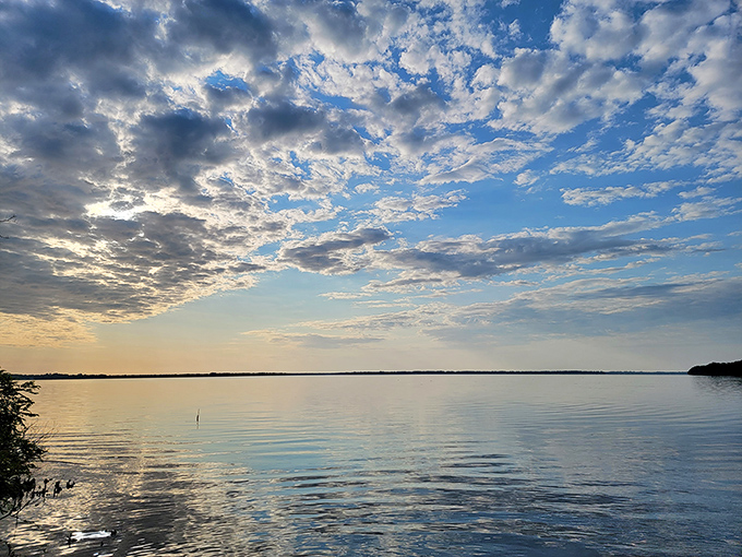 Sunset over the St. Johns River paints the sky in watercolors that would make even Bob Ross whisper "happy little clouds."