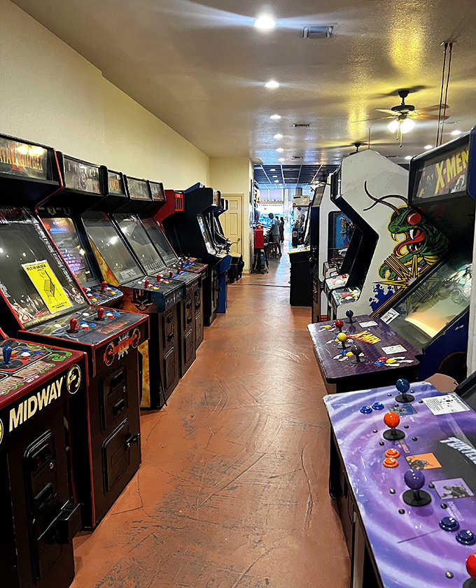Walking down this aisle is like strolling through video game history, each cabinet representing countless hours of quarters and high-score attempts.