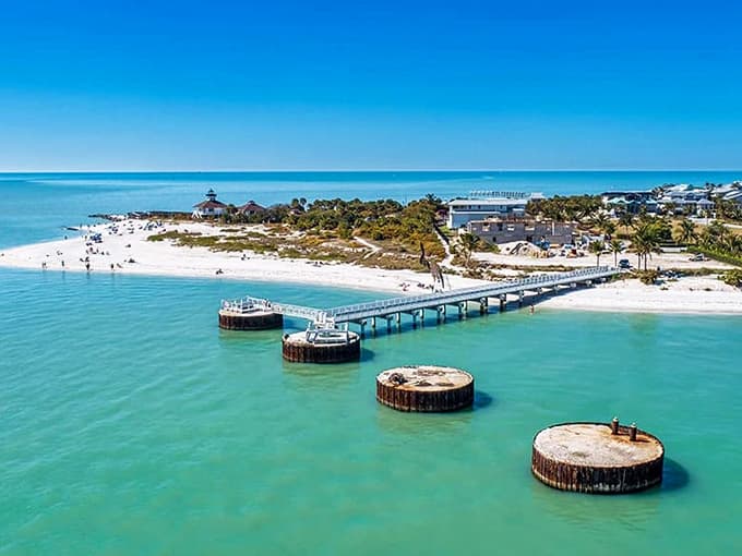 White sand beaches meeting turquoise waters showcase Florida's Gulf Coast beauty where historic structures add character to natural splendor.