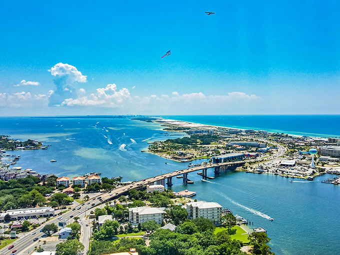 Fort Walton Beach's harbor displays luxury waterfront living with boats docked behind beautiful homes along the calm inland waters.