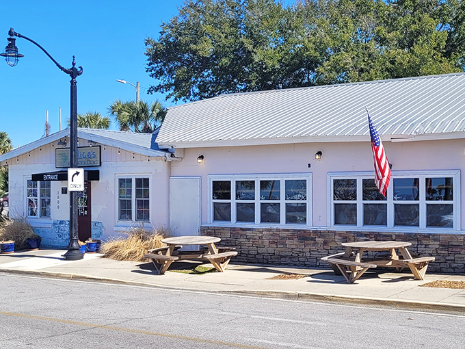 Strings of lights create magic as the sun sets over Alice's outdoor dining area. These colorful Adirondack chairs have witnessed countless perfect seafood moments.