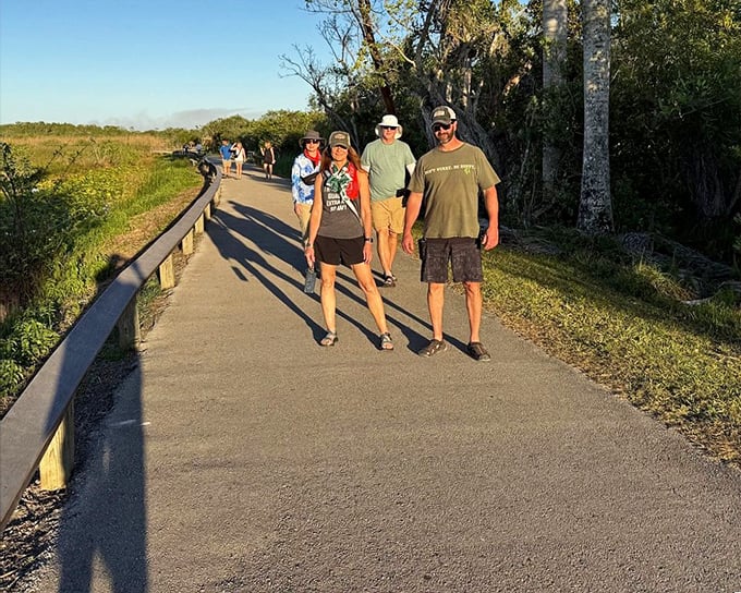 Hikers enjoy the paved section of Anhinga Trail, where the flat terrain makes this wildlife-rich experience accessible to visitors of all abilities.