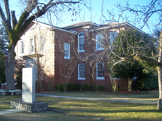 Courthouse confidence! This stately brick building has presided over small-town justice longer than Judge Judy, with better landscaping.