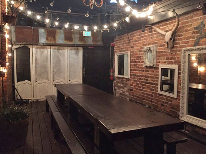 String lights cast a warm glow over Hanson's intimate rooftop space. The perfect setting for craft cocktails and quiet conversations above downtown Orlando.