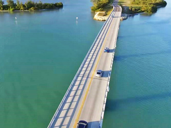 This narrow road floats between water and sky, making drivers feel like they're cruising through a dream.