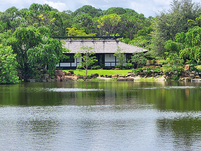 Traditional Japanese architecture creates a striking silhouette against lush tropical plantings, blending Eastern design with Florida's natural beauty.