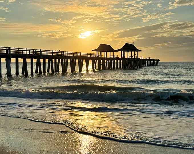 A golden sunset bathes Naples Pier in warm light, creating the postcard-perfect moment everyone comes to see.
