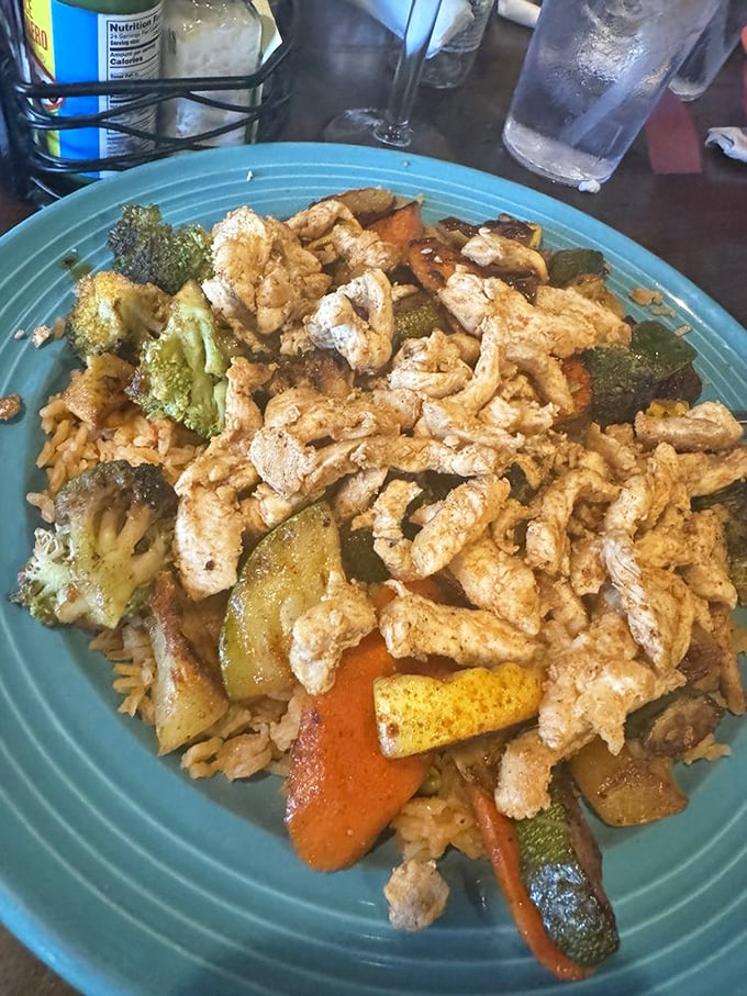 Arroz con Pollo is comfort food that happens to be Mexican, featuring grilled chicken over rice with vegetables that actually taste good.