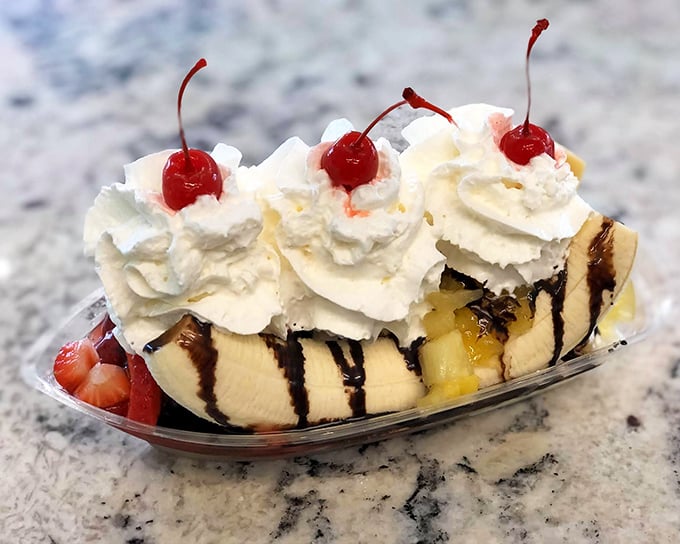 The classic banana split gets the royal treatment with fresh fruit, three generous scoops, whipped cream mountains, and the obligatory cherry on top.