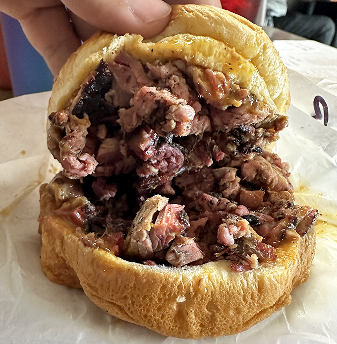 The chopped pork sandwich&mdash;a masterclass in simplicity. Every bite contains the perfect ratio of bark to tender meat, a barbecue mathematician's dream.