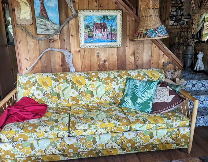 That vintage couch has probably absorbed more wisdom and folk songs than your entire living room furniture collection ever will.