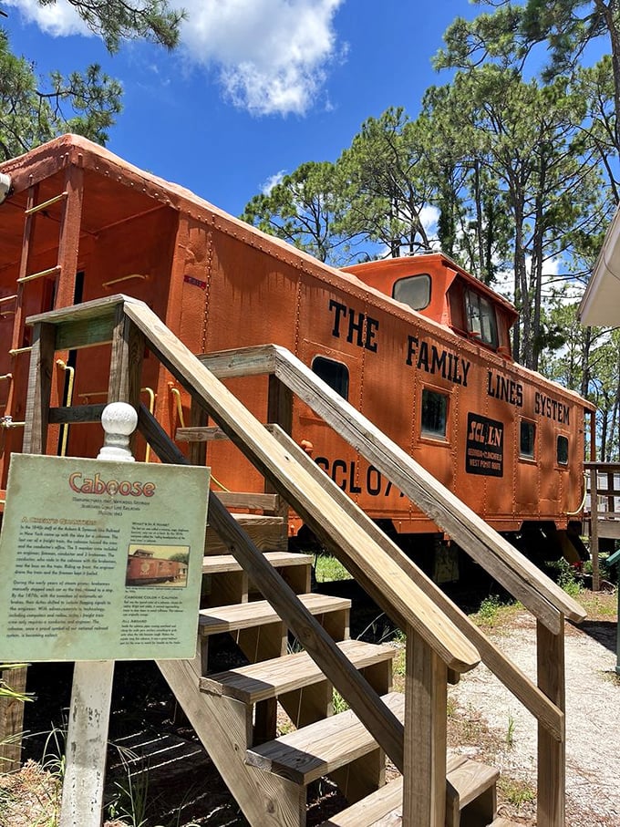 All aboard! This vibrant orange caboose once served as both workplace and temporary home for train crews crisscrossing the Sunshine State.