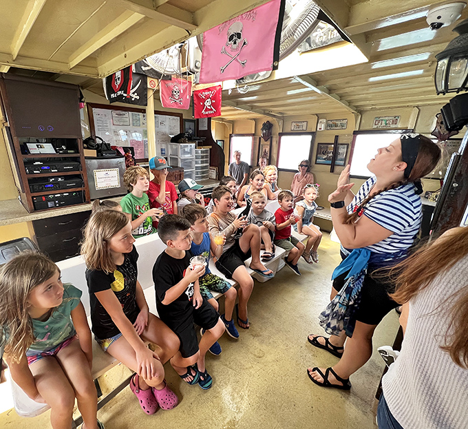 Story time on the high seas captivates young pirates, their imaginations sailing far beyond the wooden walls of the cabin.