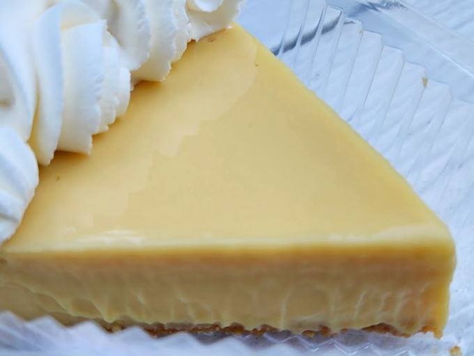 The classic Key lime pie slice &ndash; sunshine-yellow filling atop a buttery graham cracker crust, topped with a cloud of cream.
