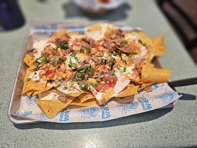 Nachos that require a strategy meeting before eating &ndash; layers of cheese, meat, and toppings create a shareable mountain of flavor.