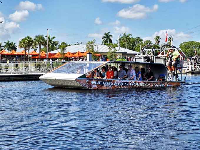 Passengers hold tight as the airboat glides through the marshes, their expressions mixing excitement with the slight concern of people who just realized how fast they're actually going.