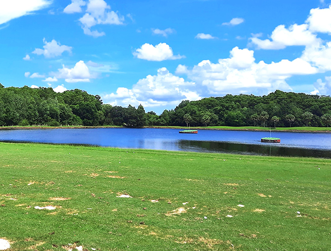 Tranquil waters reflect Florida's endless blue skies, while strategically placed floating targets challenge golfers to dial in their distance control.