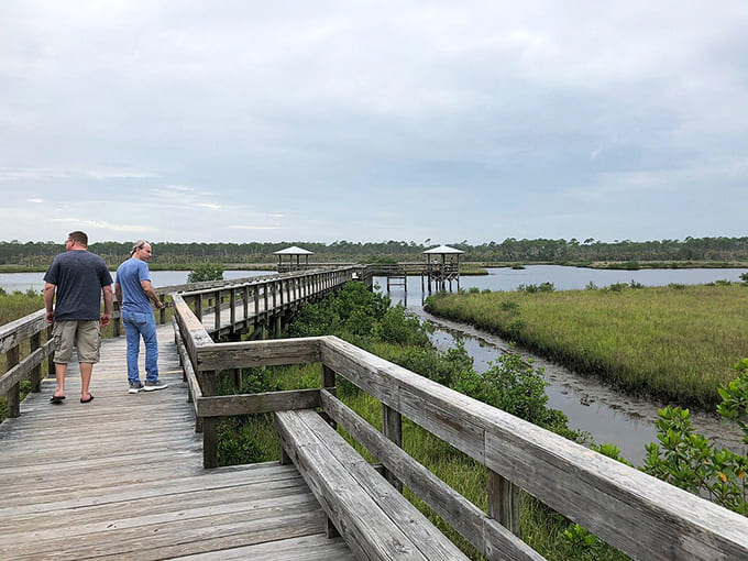 Two visitors stroll the boardwalk, probably discussing whether this view beats their usual walking route around the neighborhood.