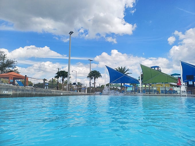 Crystal clear waters invite overheated visitors to surrender to refreshment, with shade structures standing guard against sunburn.