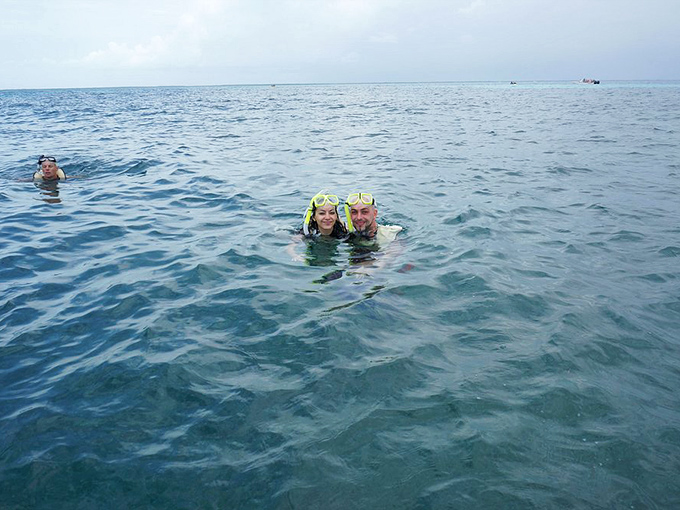 Happy snorkelers bobbing in the Florida Keys waters &ndash; their smiles above the surface hint at the wonders they've witnessed below.