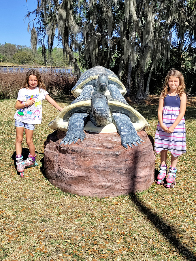 Young visitors discovering that turtles make better photo props than any social media filter could ever provide.