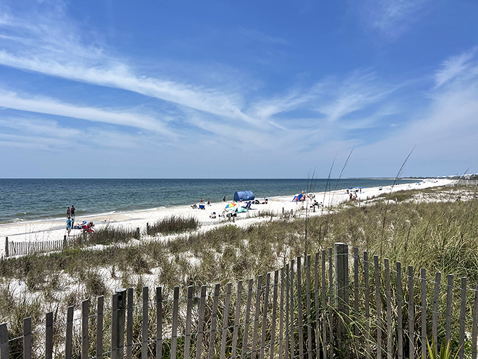 Beach-goers dot the shoreline, each creating their own version of a perfect day by the water.