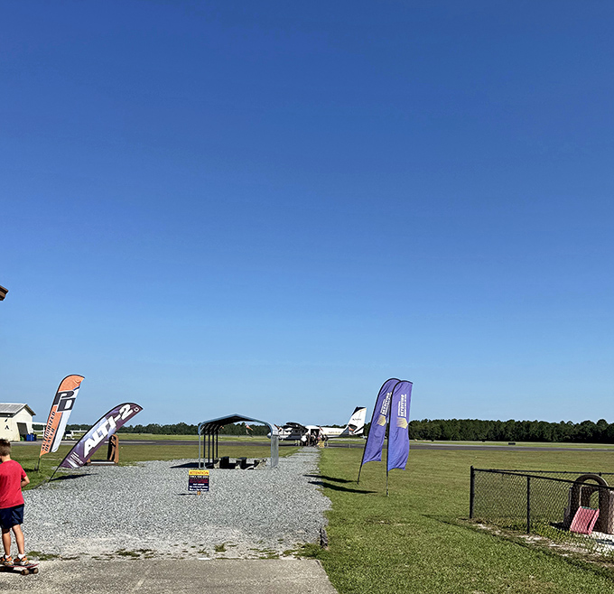 The walkway to adventure looks deceptively peaceful, like a path to a picnic rather than to an airplane you'll be exiting mid-flight.
