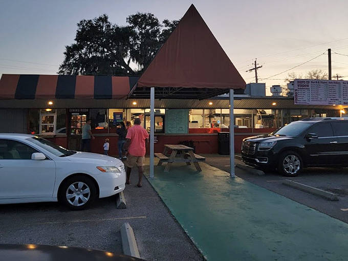 Jimbo's Pit Bar-B-Q's rustic interior features wooden picnic tables that make you feel like you're at a family cookout rather than a restaurant.