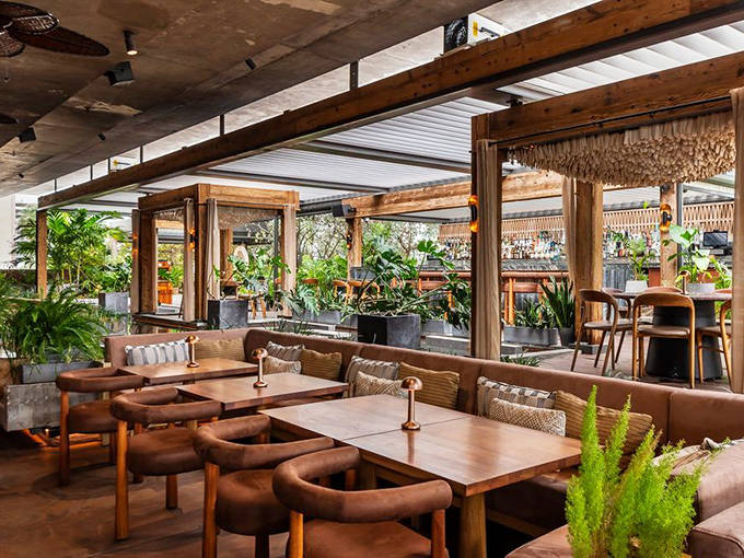 MILA's sophisticated design blends indoor-outdoor living with natural elements. Soft lighting and comfortable seating create Miami Beach's most stylish dining atmosphere.