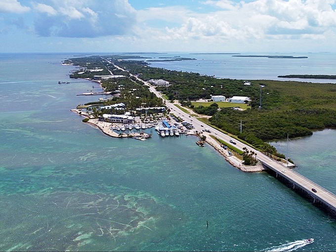 The "Village of Islands" offers waterfront dining and recreation with palm trees framing views of boats navigating the channels between keys.