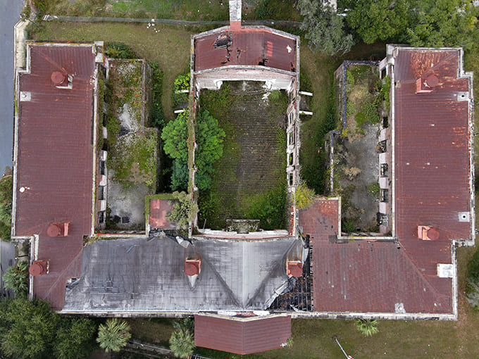 From above, the building's bones are laid bare, showing how nature slowly reclaims what humans temporarily borrowed from the earth.
