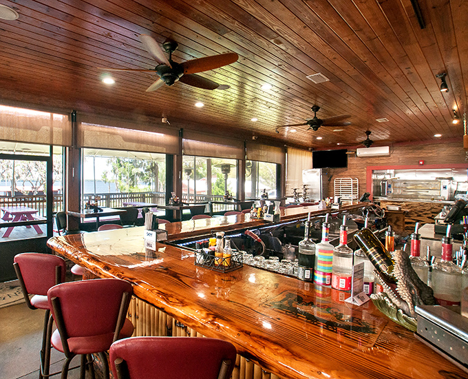 The polished wooden bar gleams invitingly, its craftsmanship showcasing natural materials that echo the resort's authentic Florida character.