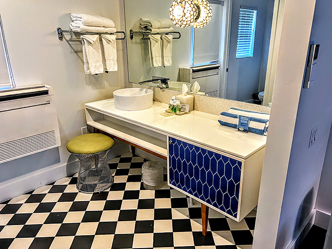 Classic checkered floors dance beneath sleek modern fixtures, creating a bathroom that's both nostalgically charming and refreshingly functional.