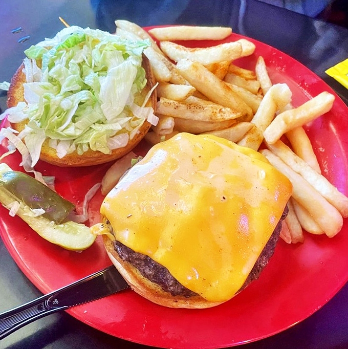 This isn't just a burger—it's architecture. The melty cheese blanket and fresh toppings create the perfect handheld meal.