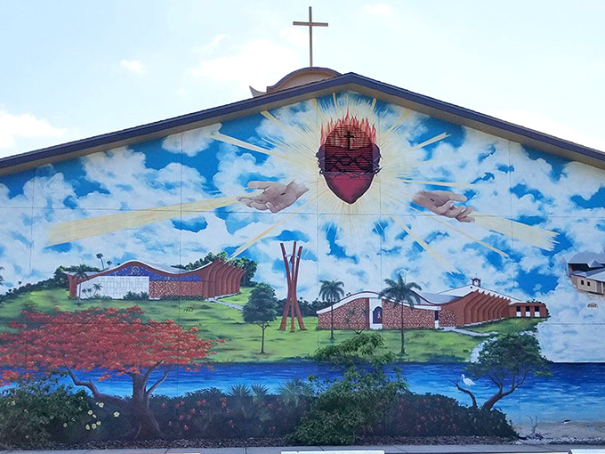 Sacred Heart's spiritual journey unfolds beneath heavenly rays, where painted faith feels as tangible as the real church nearby.