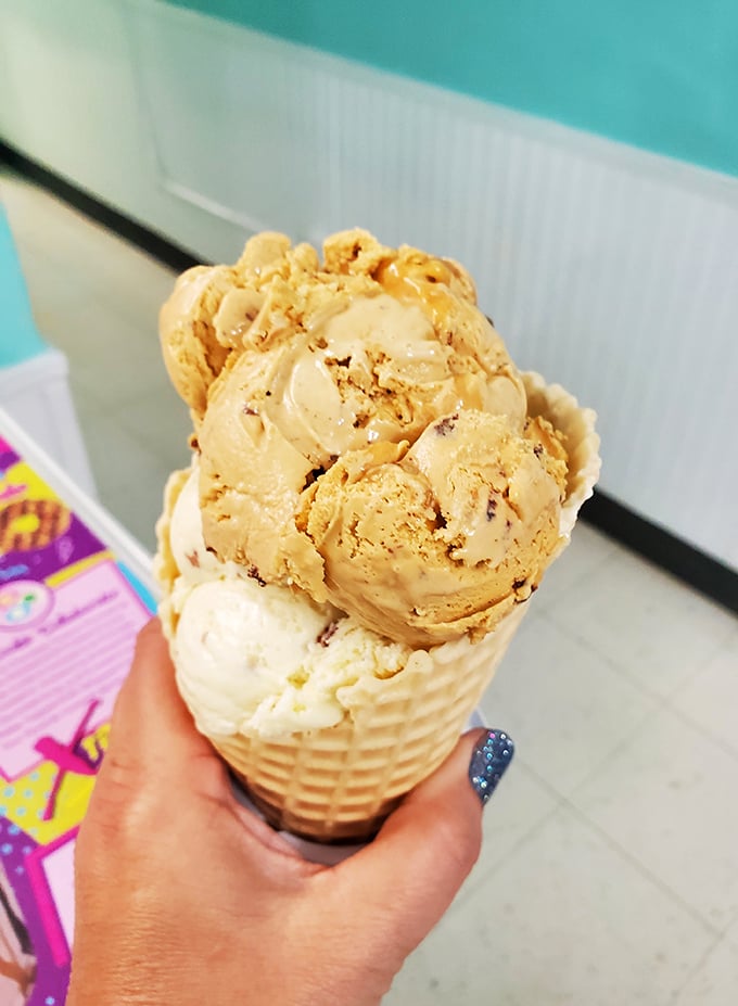 Sometimes the classics need no improvement – a perfectly swirled waffle cone showcasing butter pecan's rich, nutty goodness in all its simple glory.