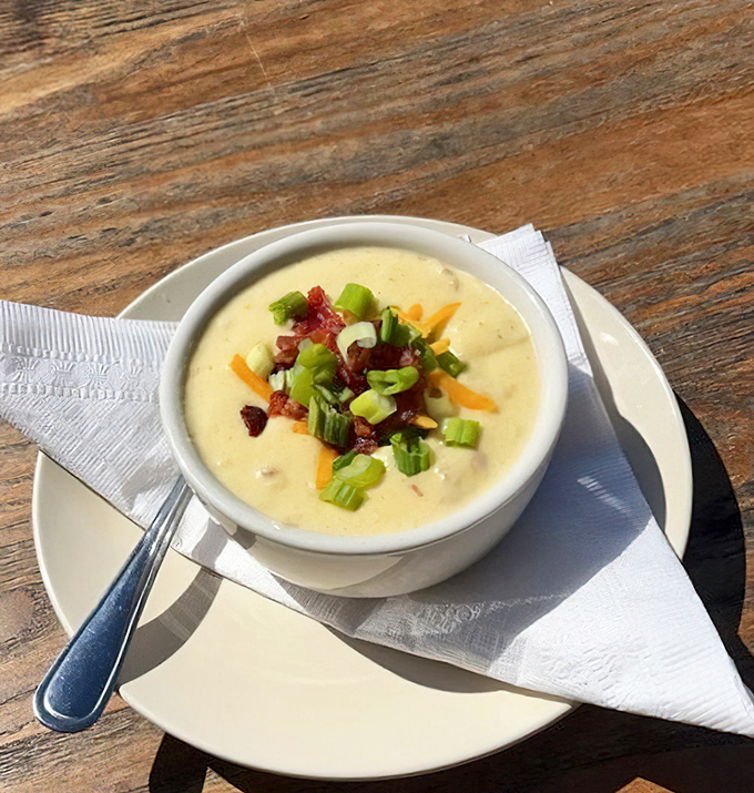 This isn't just potato soup &ndash; it's a warm hug in a bowl, topped with bacon bits and green onions that add texture to every velvety spoonful.