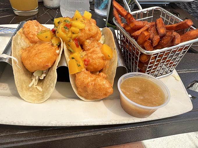 Plump Gulf shrimp nestled in soft tortillas with mango salsa and a basket of sweet potato fries &ndash; Florida in every bite.