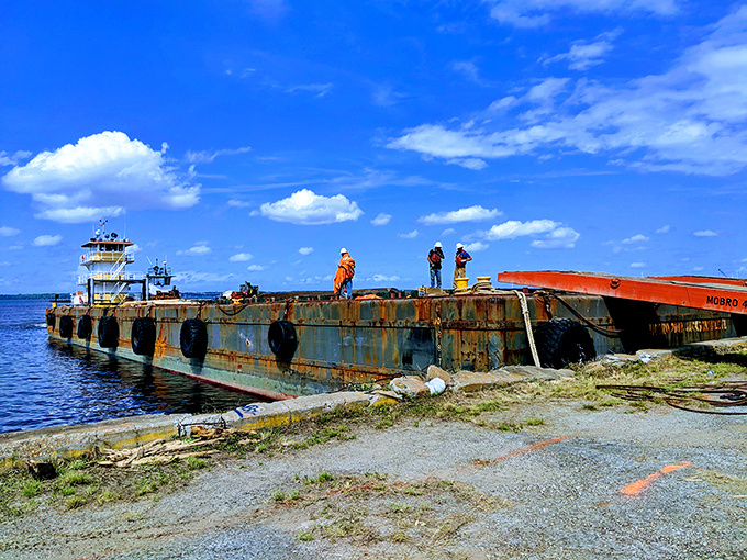 The rusted barge and industrial equipment offer a stark contrast to Florida's blue skies. Not the space shuttle tank, but part of Green Cove Springs' working waterfront heritage.