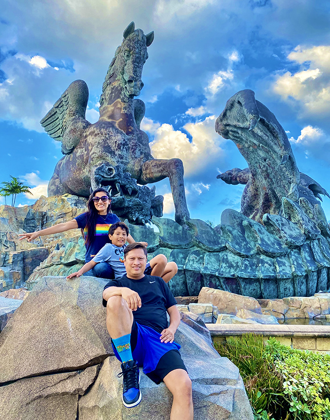 Families create memories beneath wings that span the sky – perspective making even adults feel child-sized against mythological might.