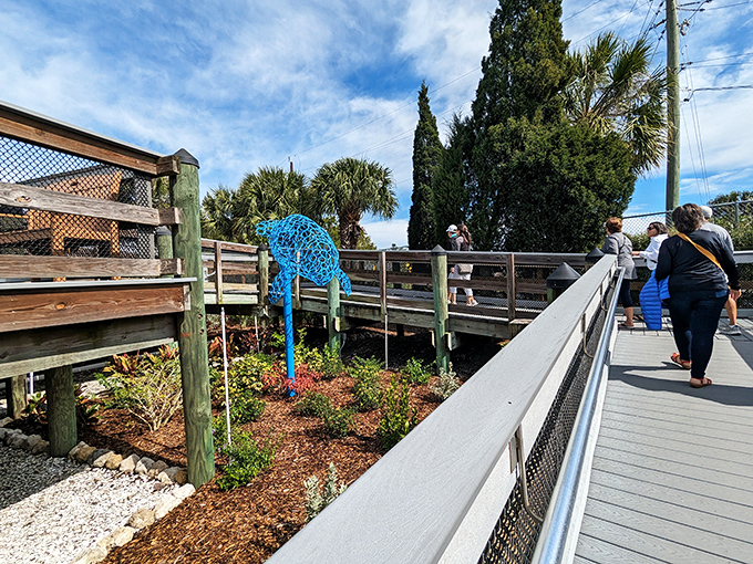 Visitors lean eagerly over the railings, their expressions mirroring the childlike wonder that even the most jaded adults rediscover here.