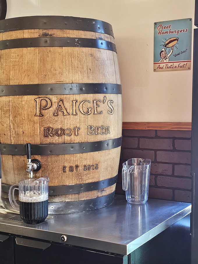 The wooden barrel isn't just decoration&mdash;it's the source of Paige's legendary root beer, dispensing liquid happiness one mug at a time.