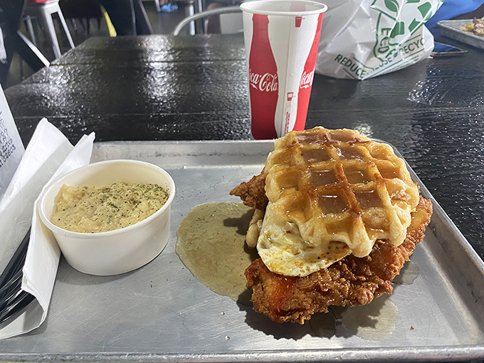 Southern comfort food reaches its final form: crispy fried chicken perched atop a golden waffle with gravy standing by for dipping duty.