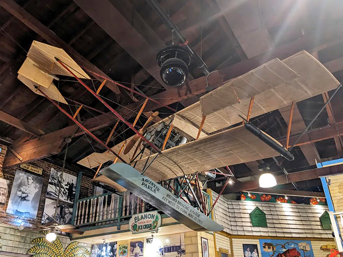 Aviation history gets the Sanchez treatment with this detailed hydroplane replica hanging from the museum ceiling &ndash; flight meets folk art!